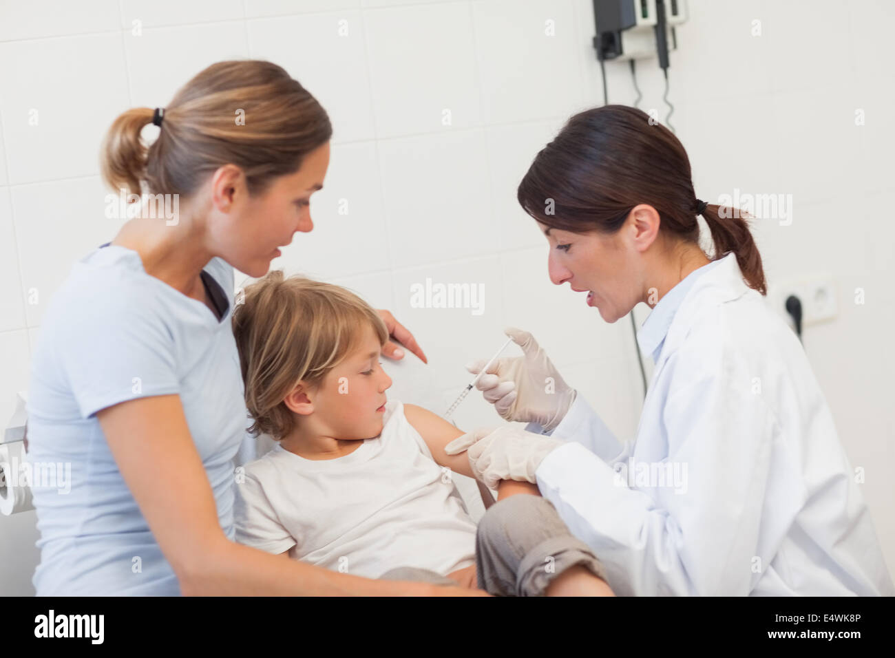Child receiving an injection by a doctor Stock Photo - Alamy