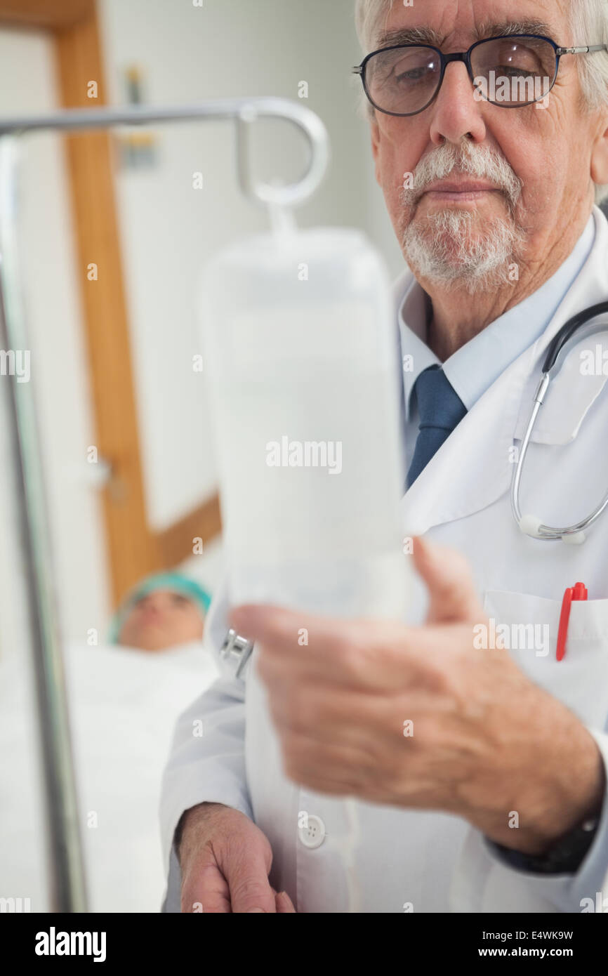 Doctor checking an intravenous drip Stock Photo - Alamy