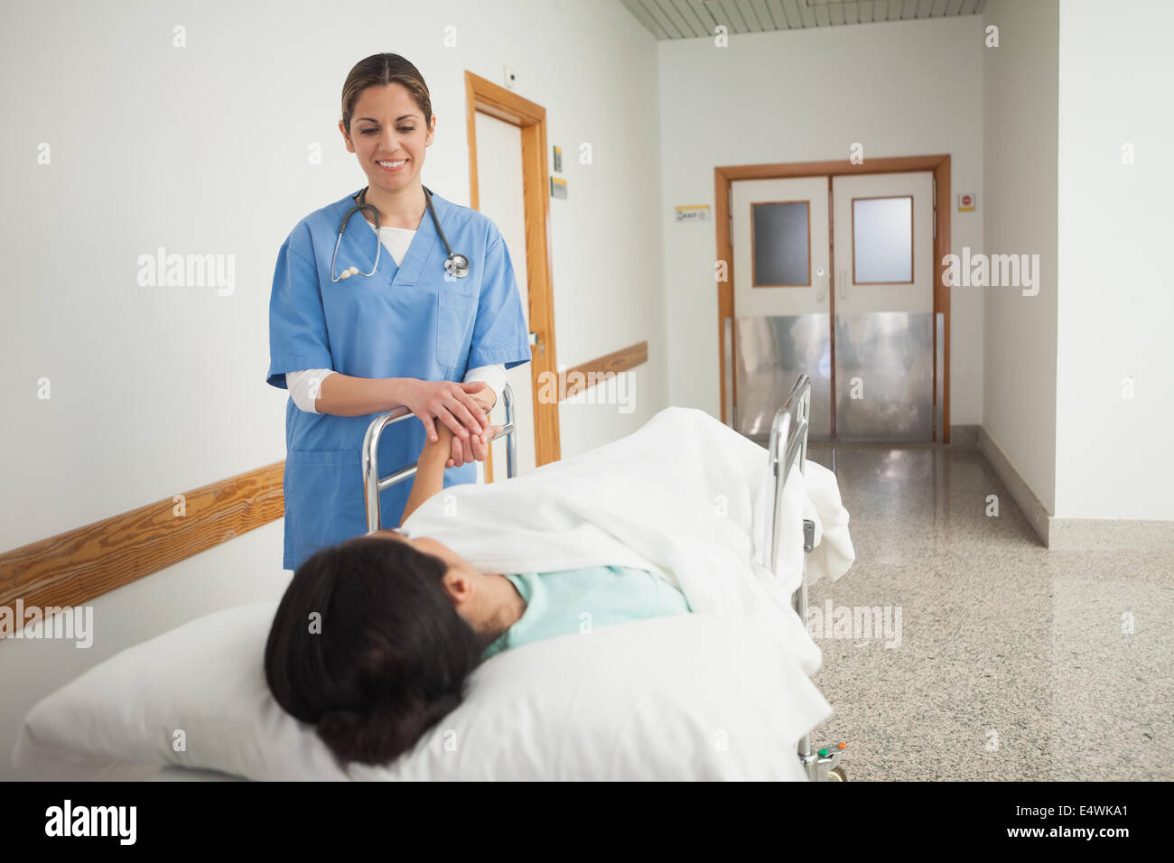 Female patient holding the hand of a nurse Stock Photo - Alamy