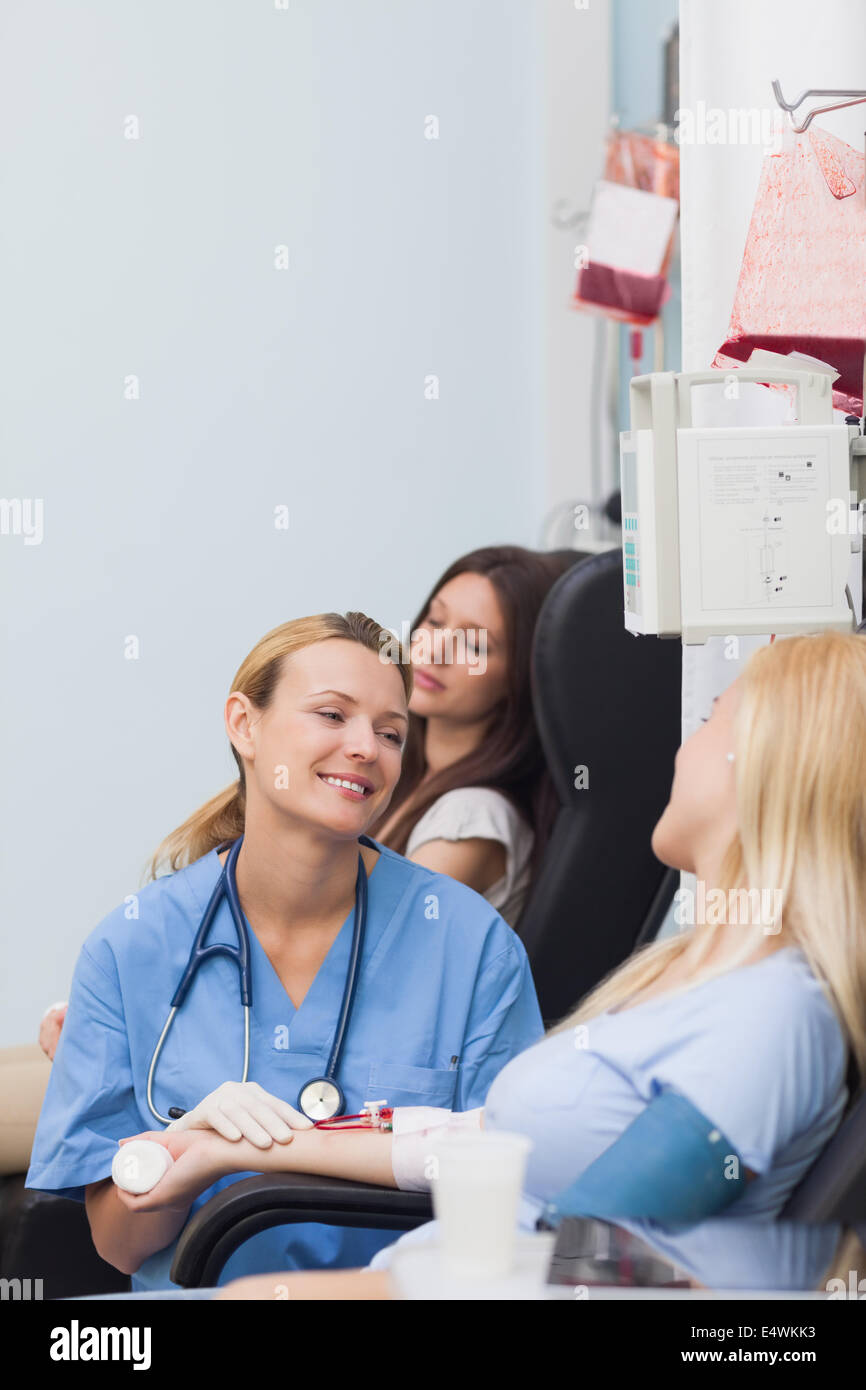 Nurse smiling to a blood donor Stock Photo - Alamy