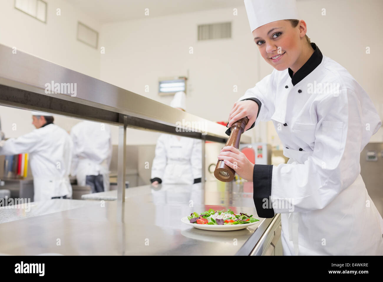 Woman chef seasoning salad hi-res stock photography and images - Alamy