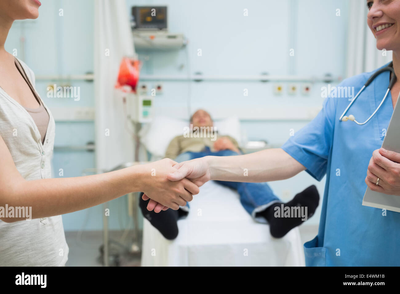 Nurse shaking hand of a patient Stock Photo - Alamy