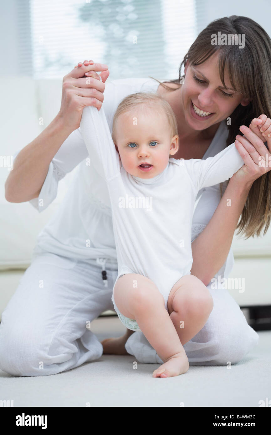 Mother raising arms of her baby Stock Photo - Alamy