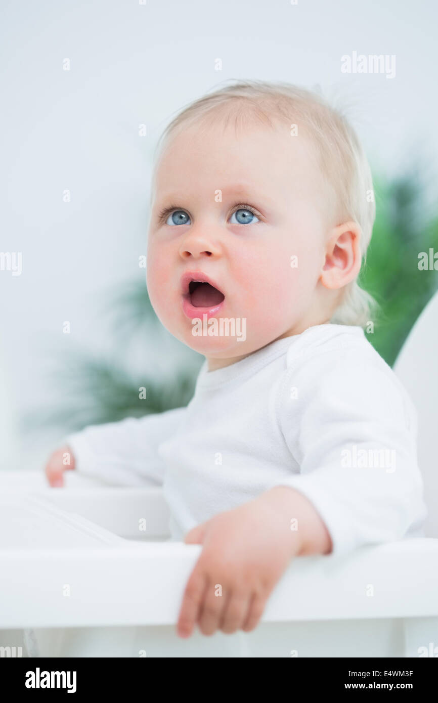 Baby sitting on a high chair Stock Photo - Alamy