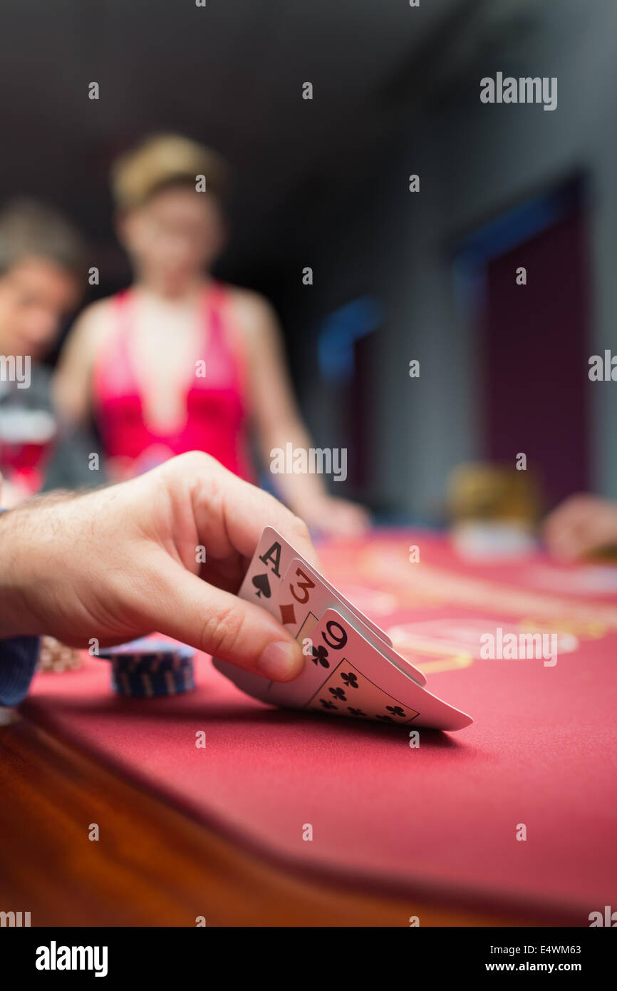 Man lifting poker hand Stock Photo - Alamy