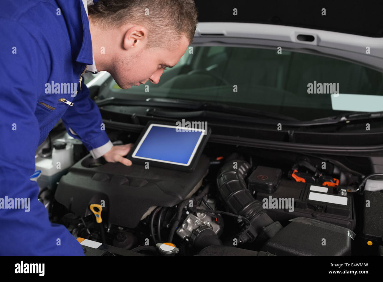Mechanic checking an engine Stock Photo - Alamy