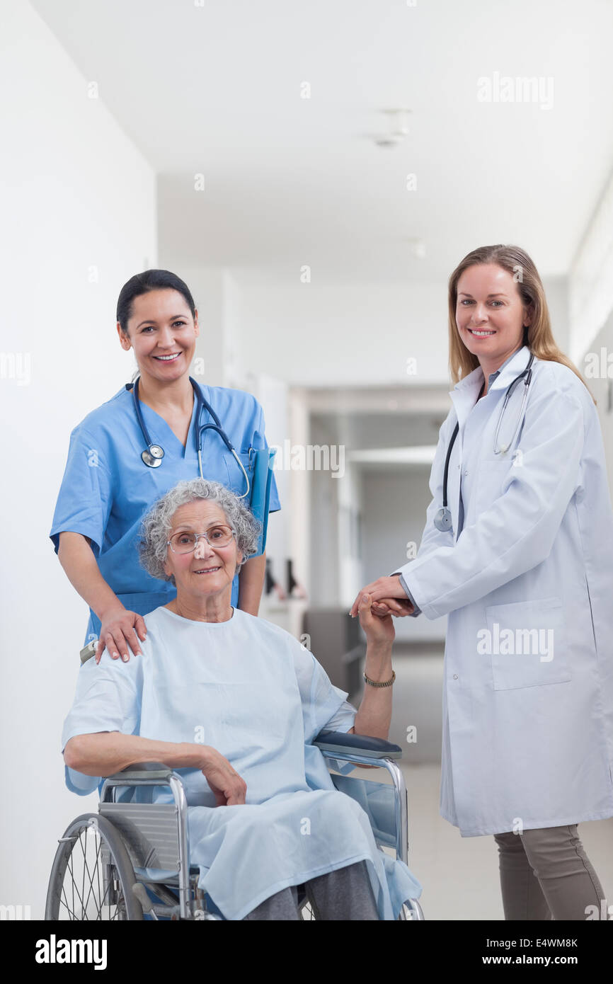 Doctor next to a patient on wheelchair Stock Photo - Alamy