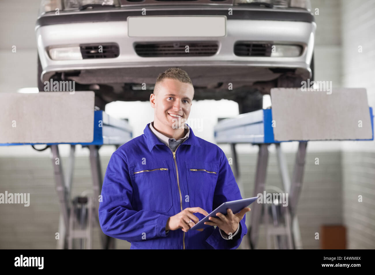 Mechanic smiling using digital hi-res stock photography and images - Alamy
