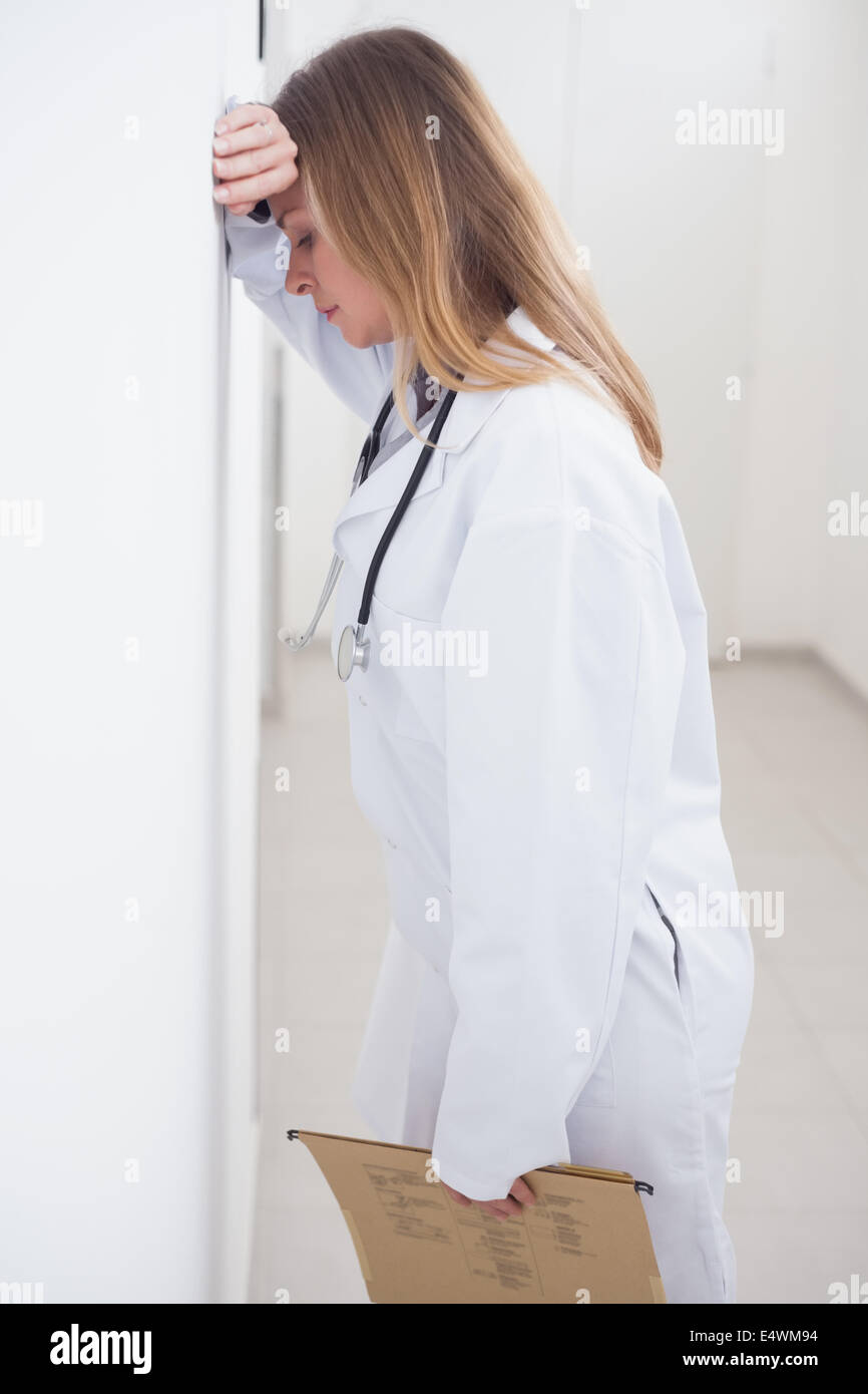 Doctor leaning on the wall Stock Photo - Alamy