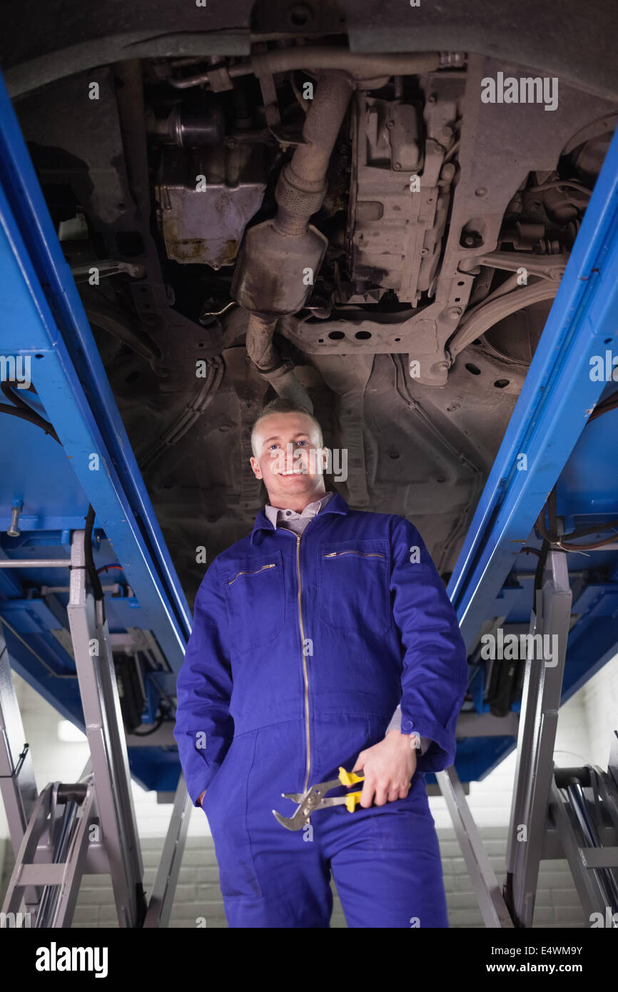 Mechanic standing repairing below hi-res stock photography and images ...