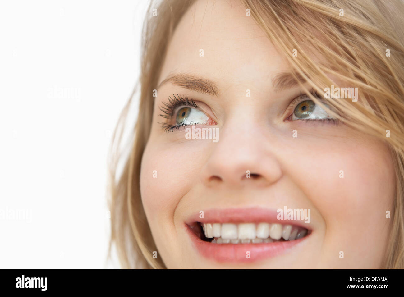 Woman looking up while smiling Stock Photo - Alamy