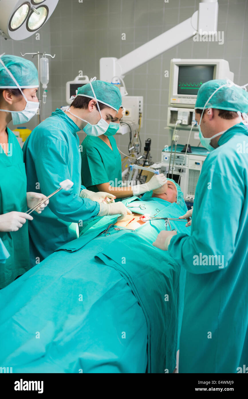 Surgeons around the operating table Stock Photo - Alamy