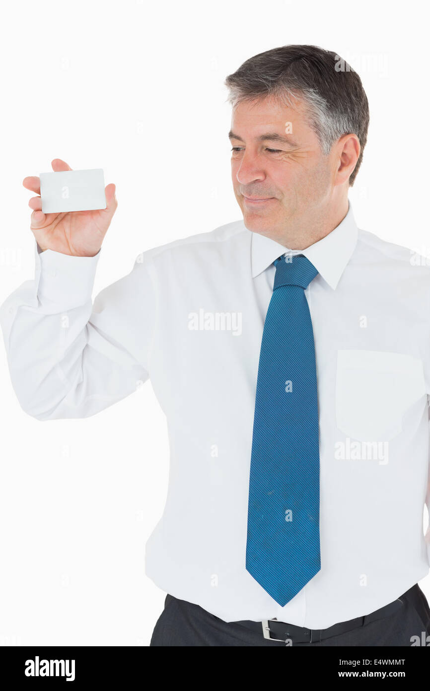 Smiling businessman showing card Stock Photo - Alamy