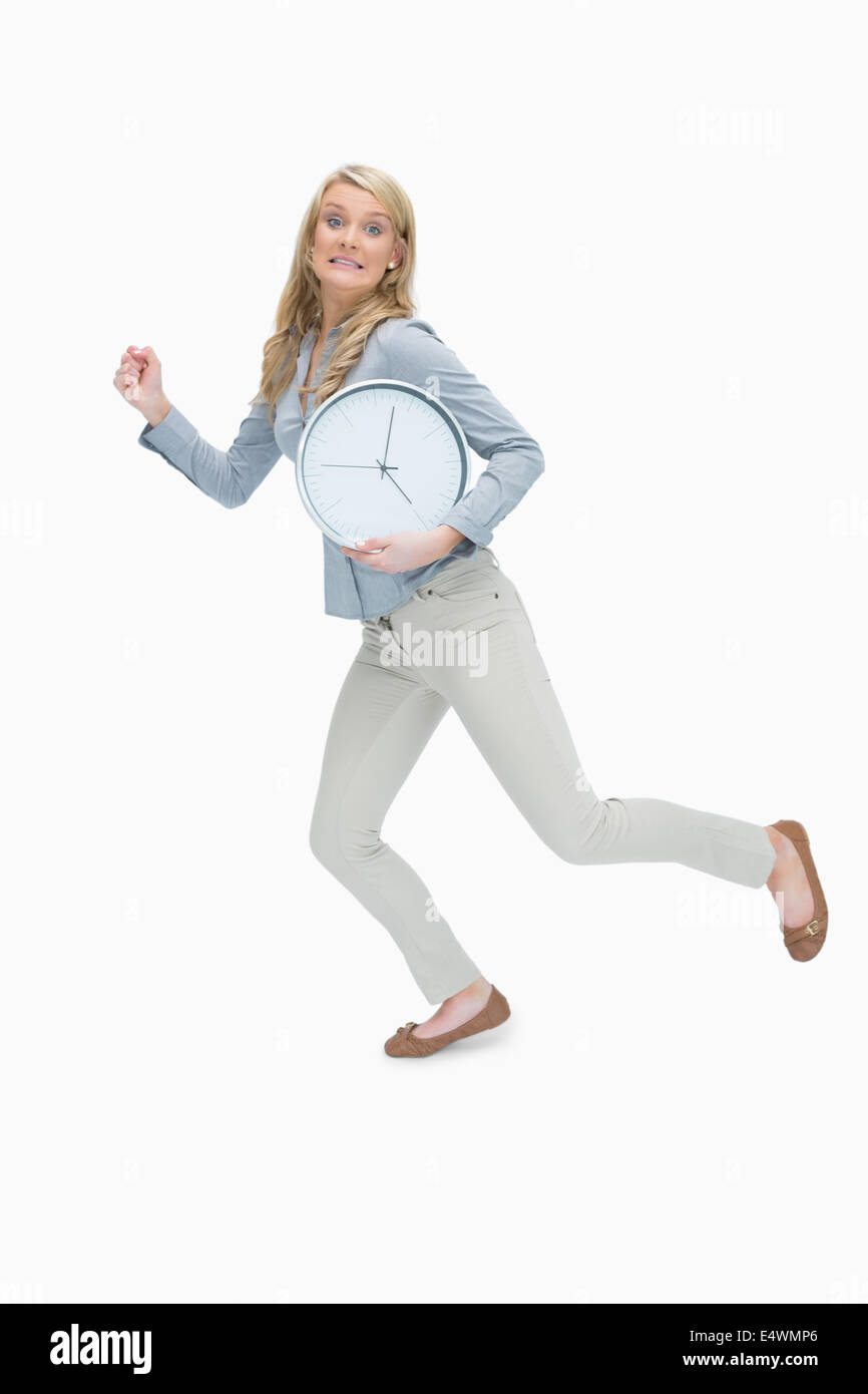 Woman running while holding a clock Stock Photo - Alamy