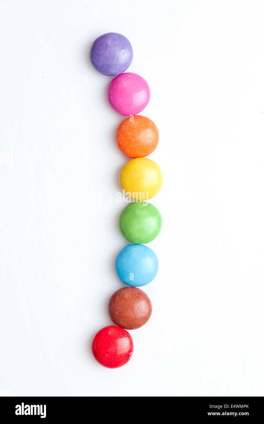 Chocolate candies in a line Stock Photo - Alamy