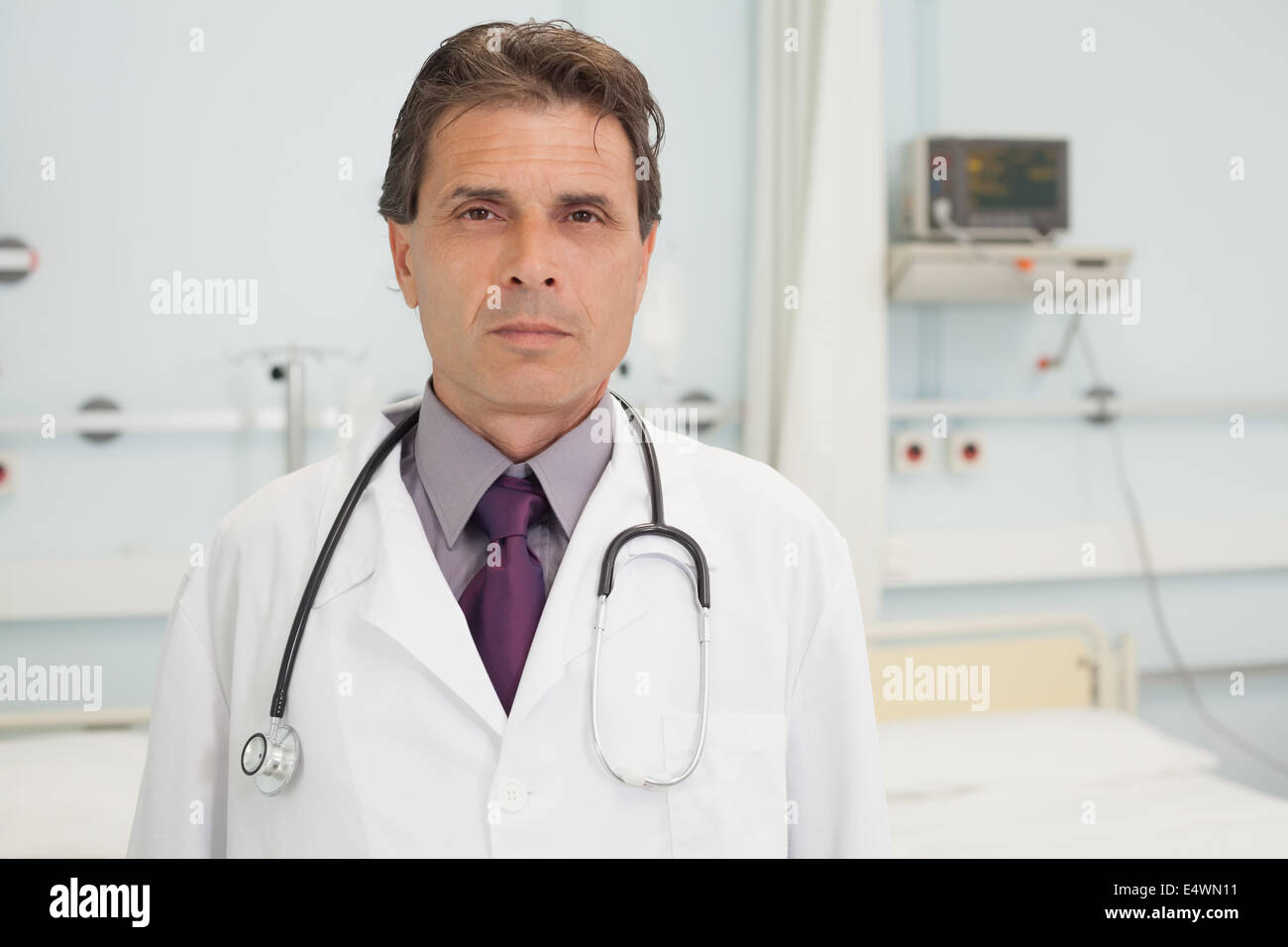 Doctor standing in hospital bedroom Stock Photo - Alamy