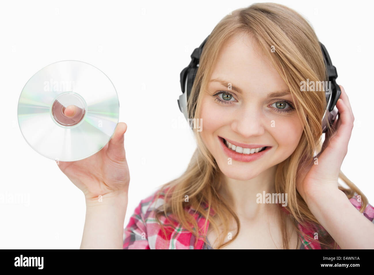 Woman smiling while holding a cd Stock Photo - Alamy