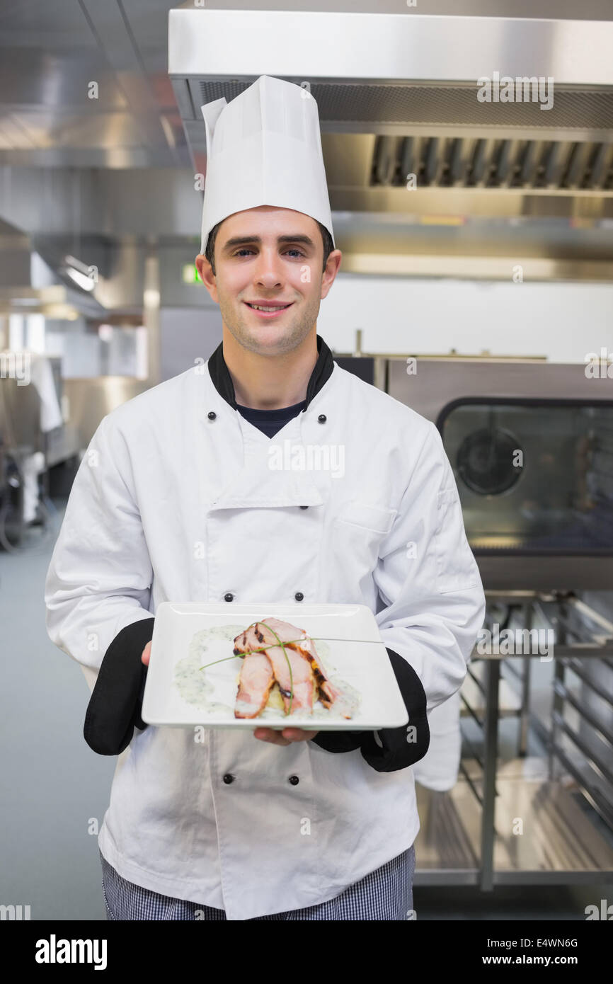 Happy chef presenting his dish Stock Photo - Alamy