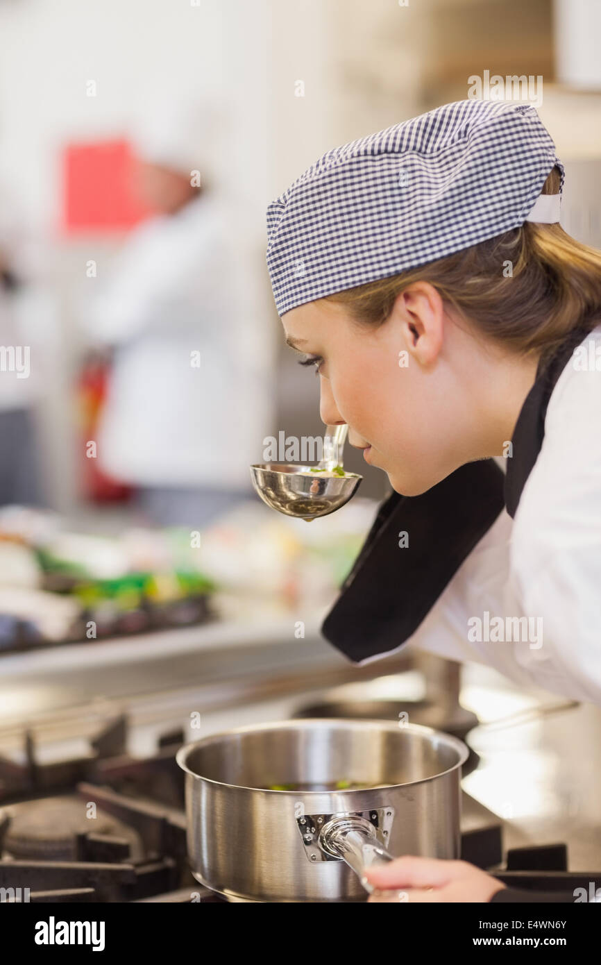 Chef smelling her soup Stock Photo - Alamy