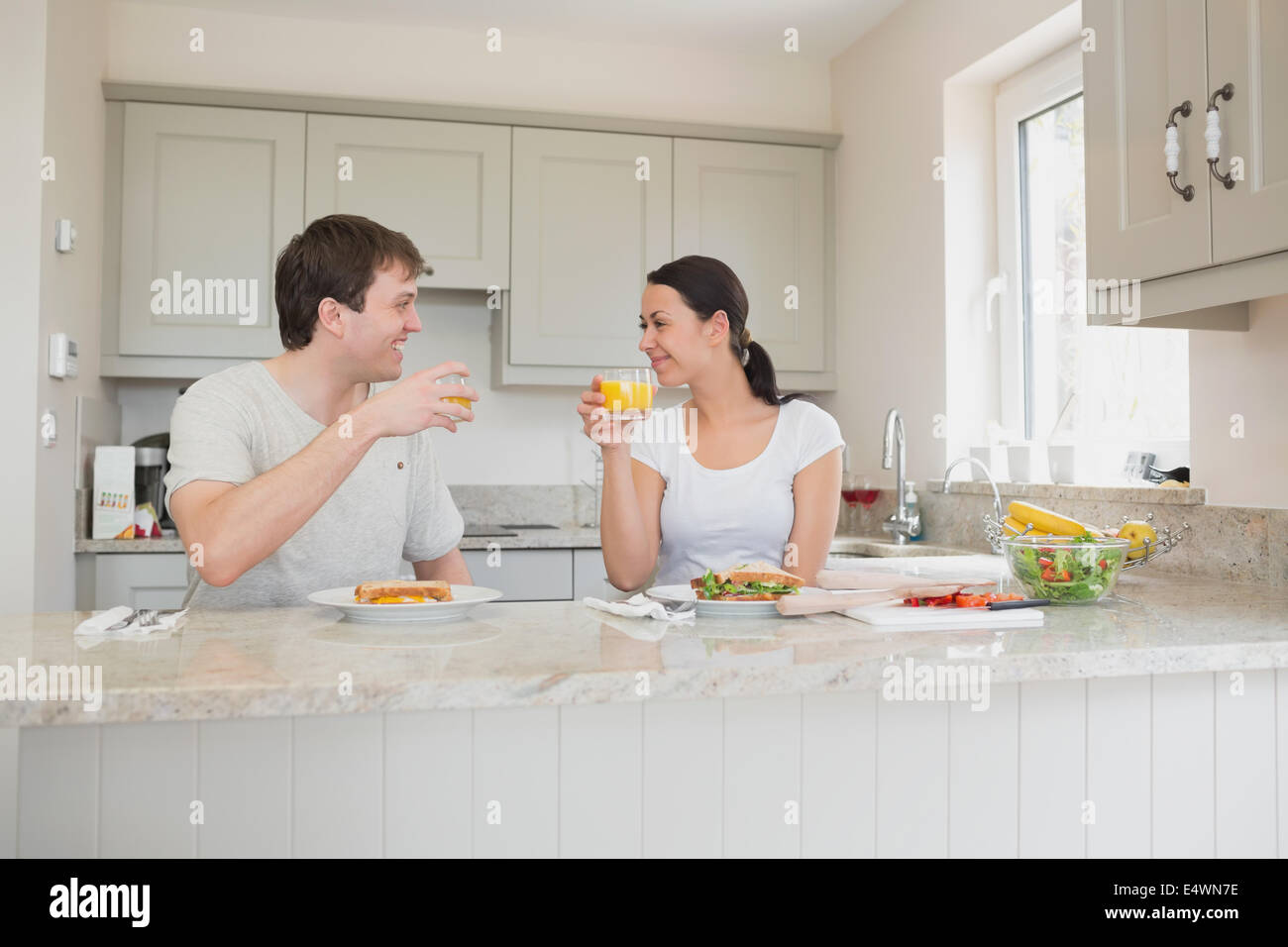 Two young people having lunch Stock Photo - Alamy