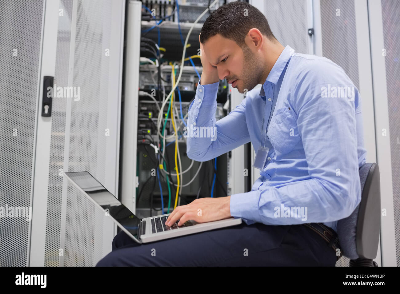 Technician becoming stressed over servers Stock Photo - Alamy