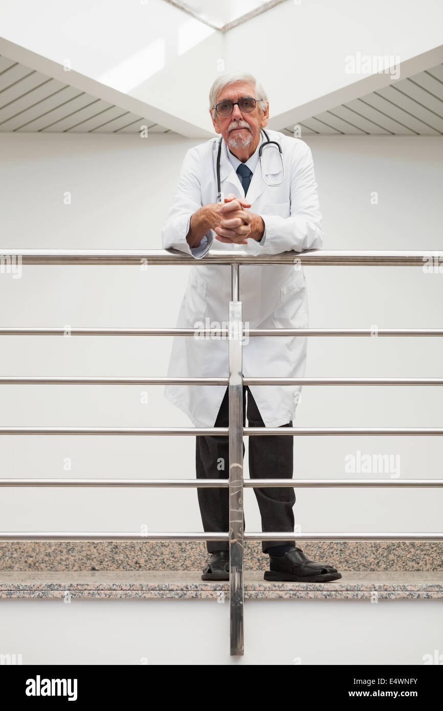 Doctor leaning on the railing Stock Photo - Alamy