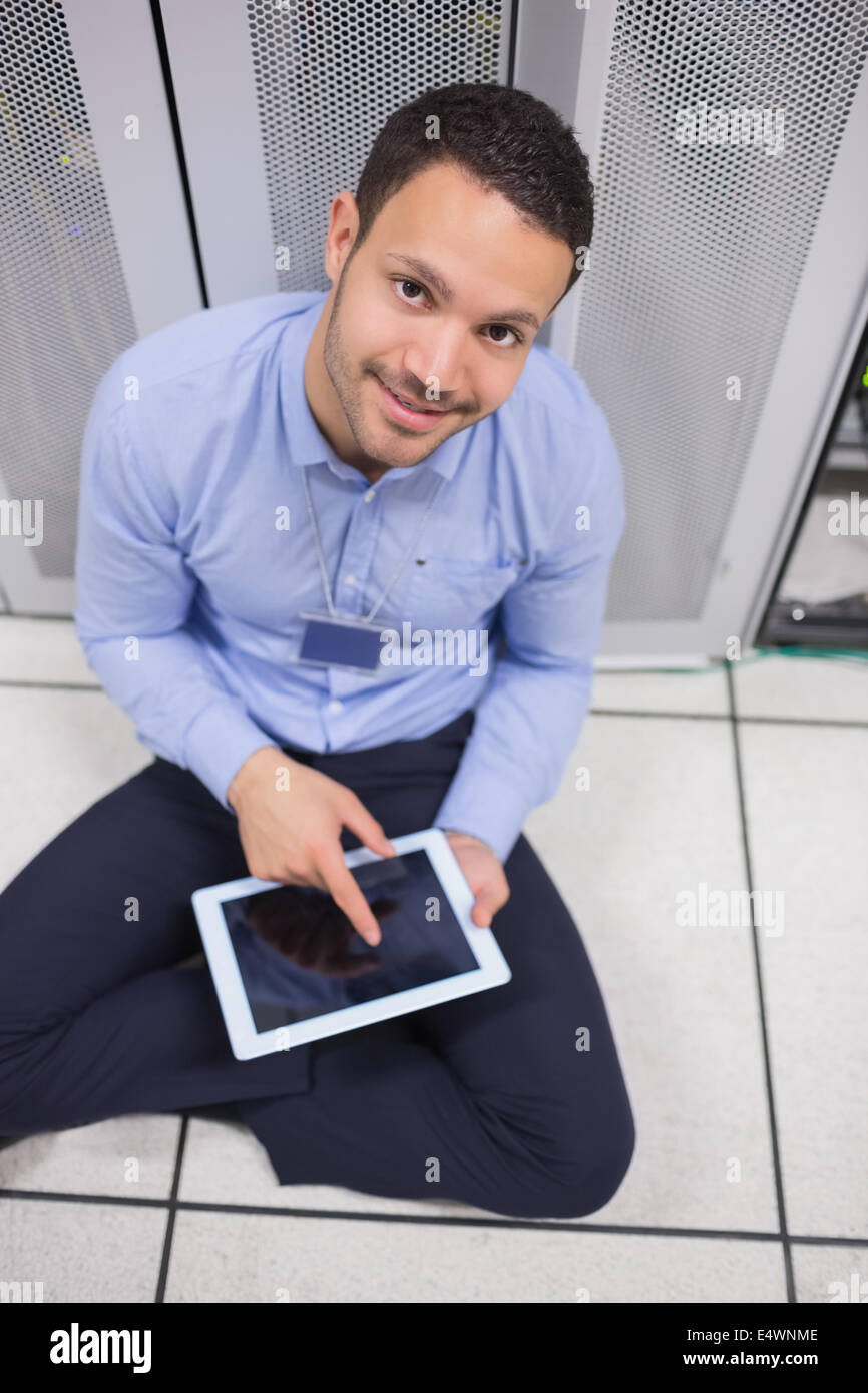 Smiling technician using tablet hi-res stock photography and images - Alamy