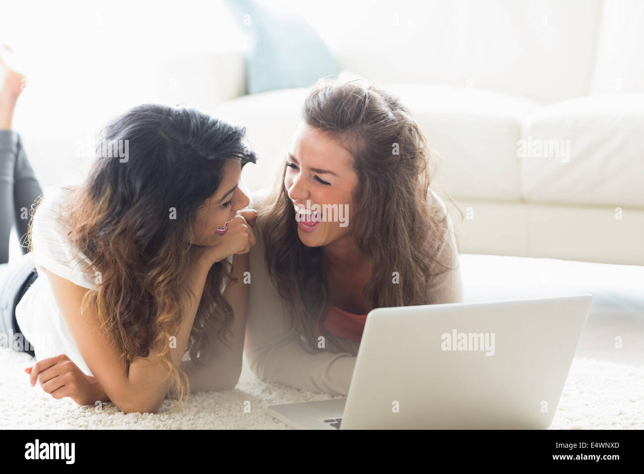 Two laughing women with a computer Stock Photo - Alamy