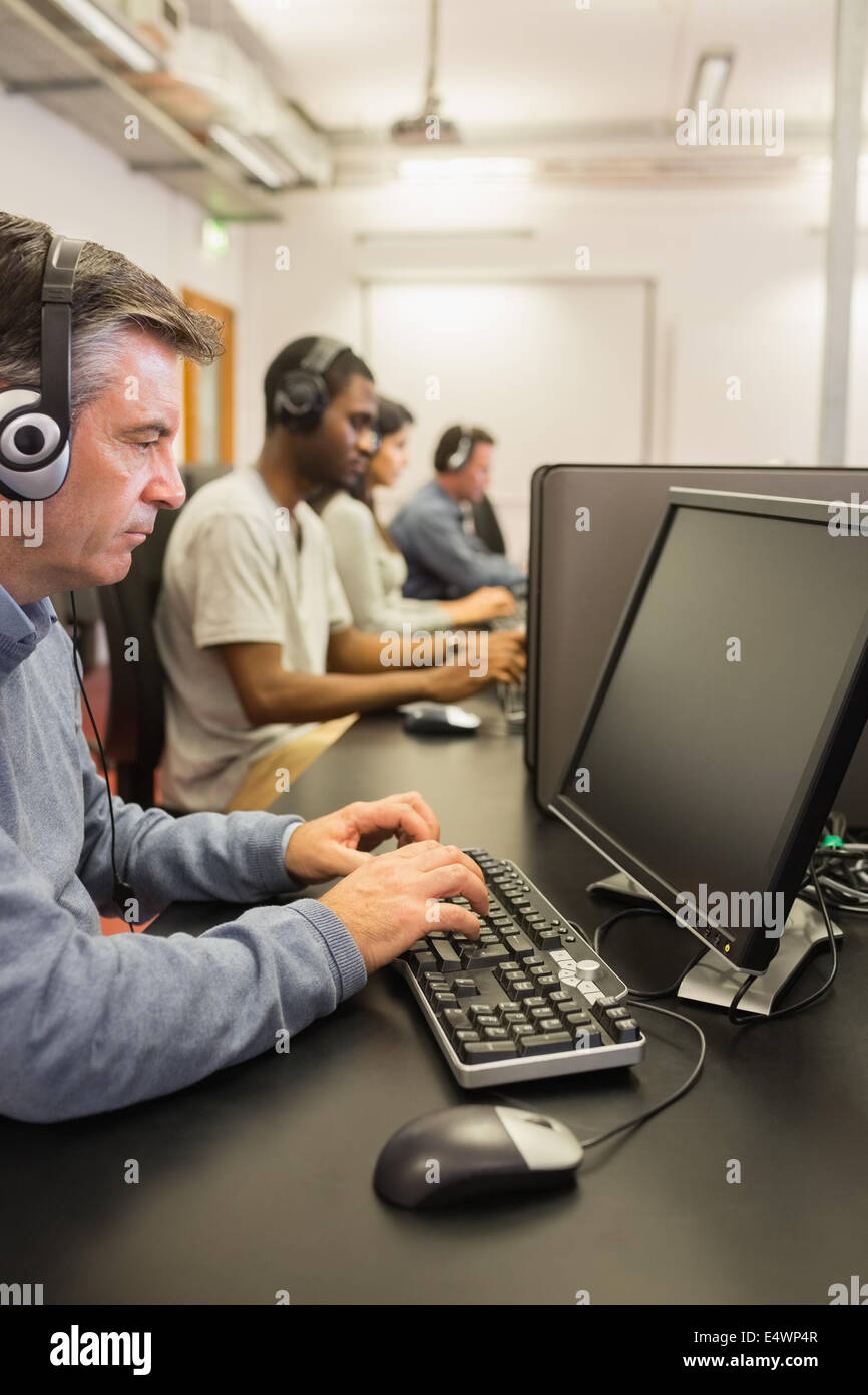 Man working in computer class Stock Photo - Alamy