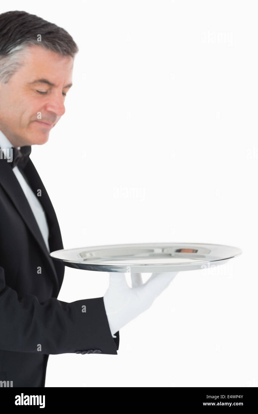 Waiter looking and holding a silver tray Stock Photo - Alamy