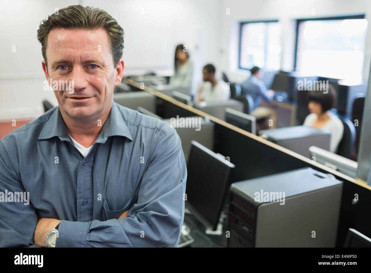 Man smiling at front of computer class Stock Photo - Alamy