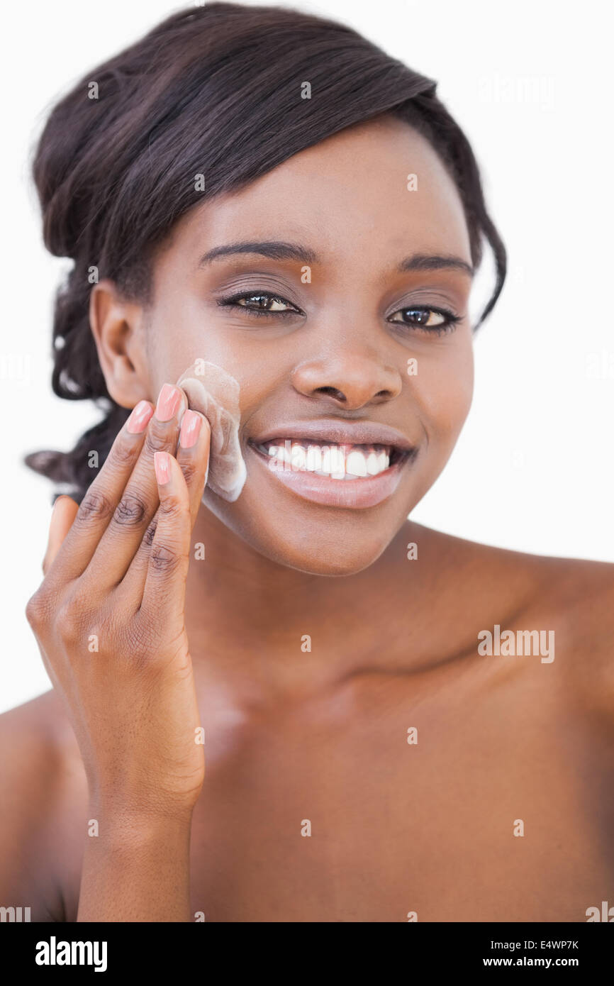 Woman putting on face cream smile hi-res stock photography and images ...
