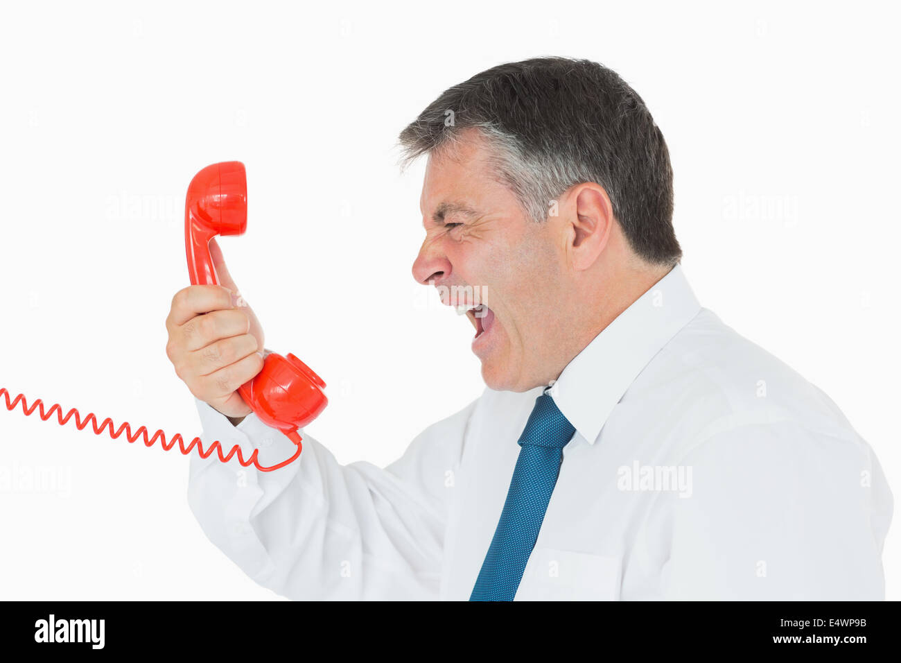 Angry businessman yelling at phone Stock Photo - Alamy