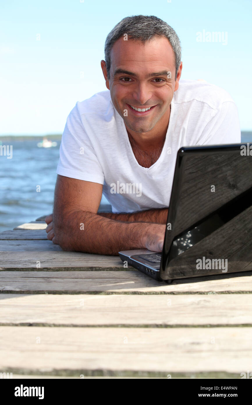Man on laptop beach hi-res stock photography and images - Alamy