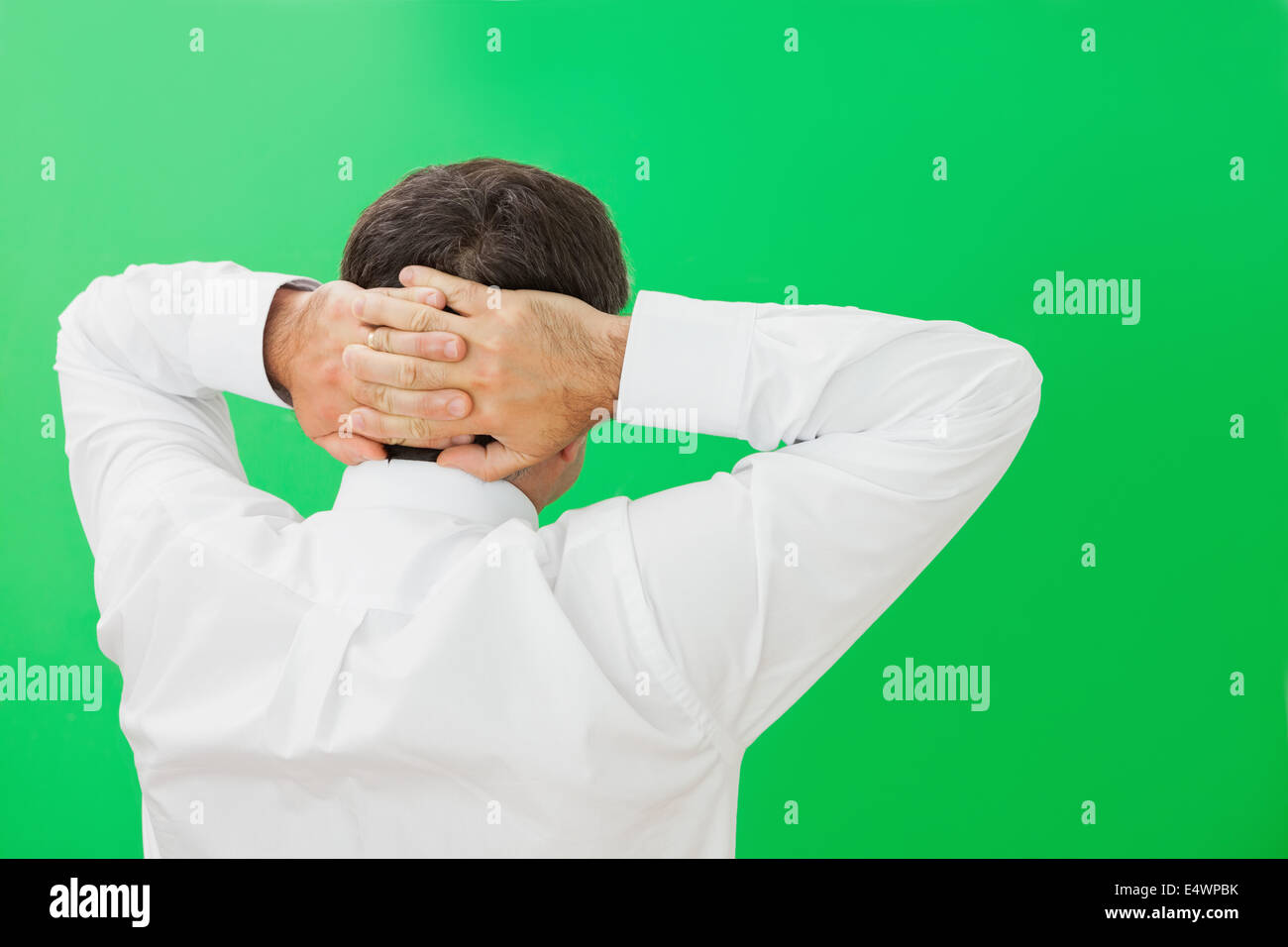 Businessman with hands on back of head Stock Photo - Alamy