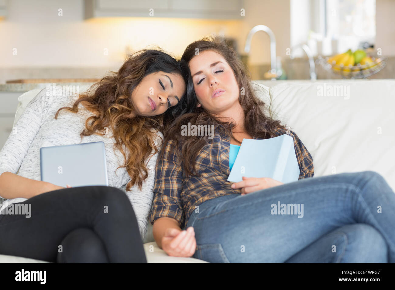 Two women napping on couch Stock Photo - Alamy