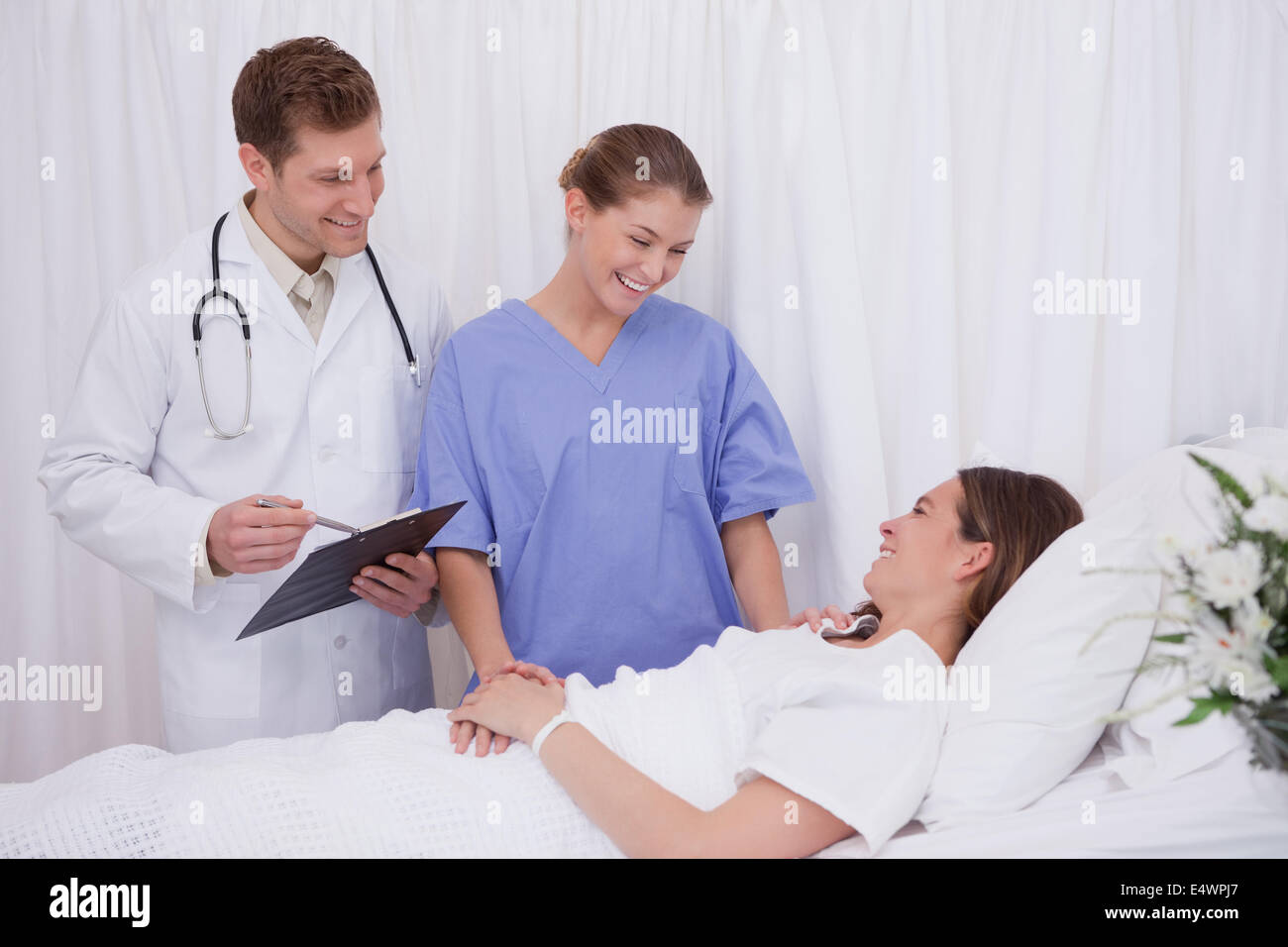 Medical team talking to patient Stock Photo - Alamy