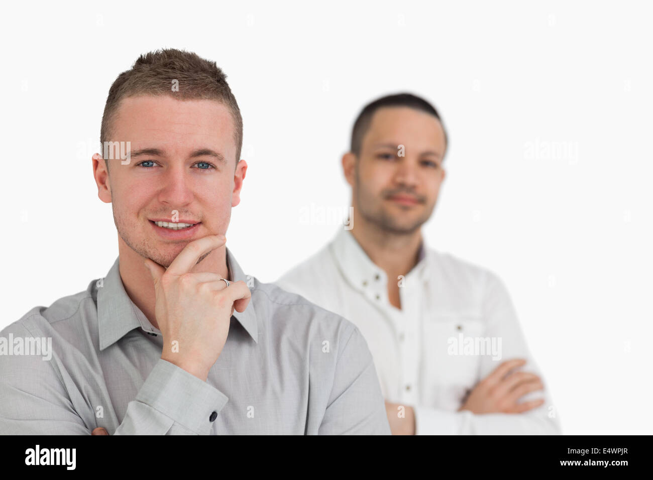 Smiling men crossing their arms Stock Photo - Alamy