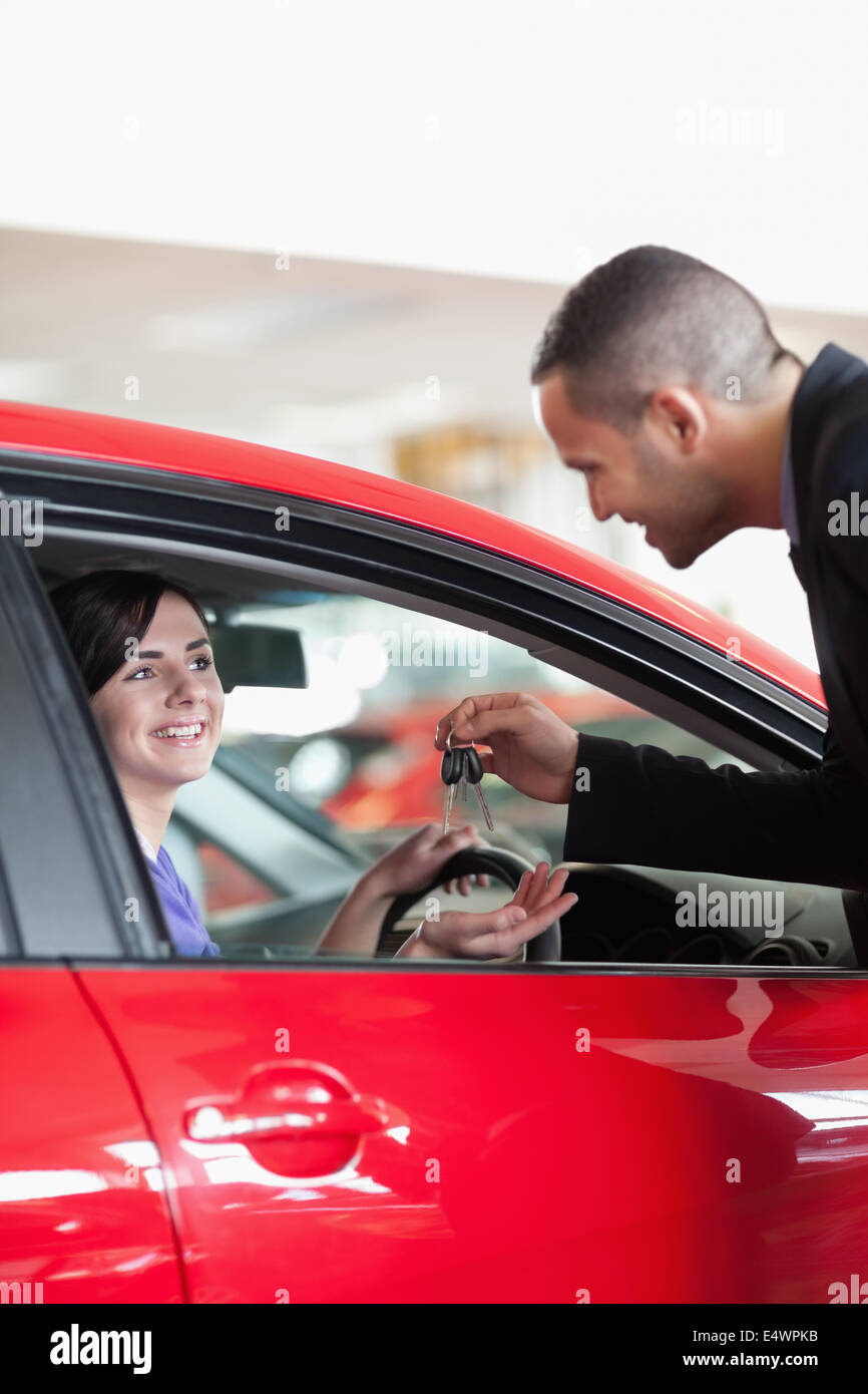 Smiling woman receiving car keys Stock Photo - Alamy