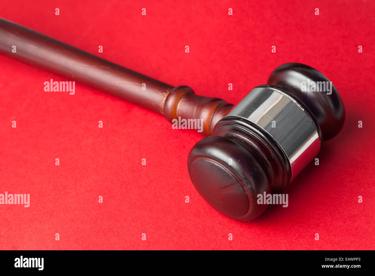 Gavel on a red background Stock Photo - Alamy