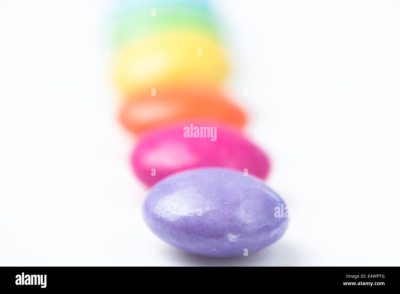 Line of candies multi coloured Stock Photo - Alamy