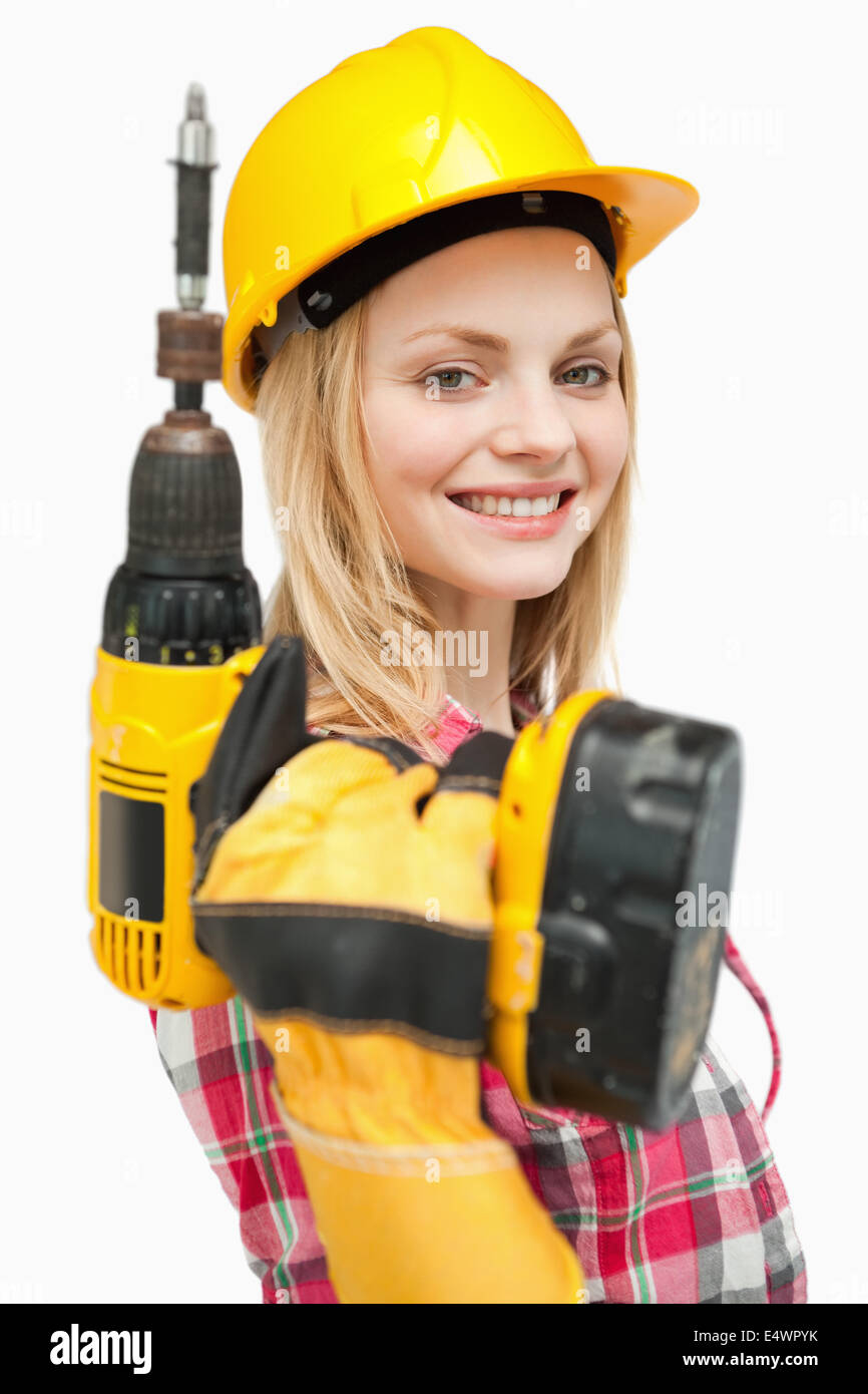 Smiling woman holding an electric screwdriver Stock Photo - Alamy