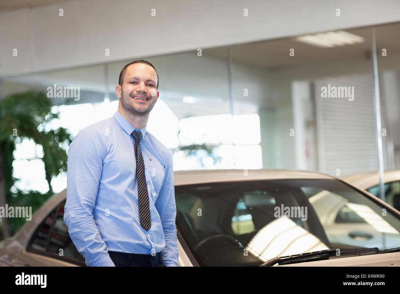 Man standing between cars Stock Photo - Alamy