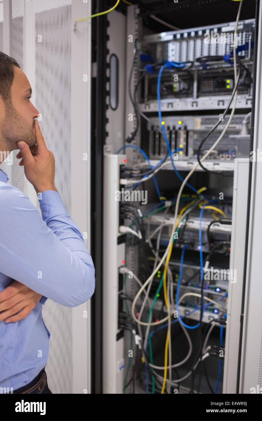 Thoughtful man looking at servers Stock Photo - Alamy