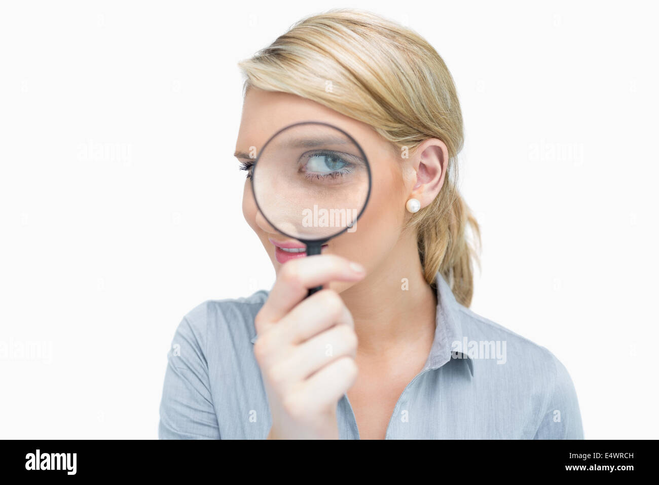 Businesswoman looking through magnifying glass Stock Photo - Alamy