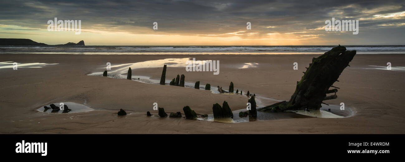 Landscape panorama shipwreck on Rhosilli Bay beach in Wales at sunset ...