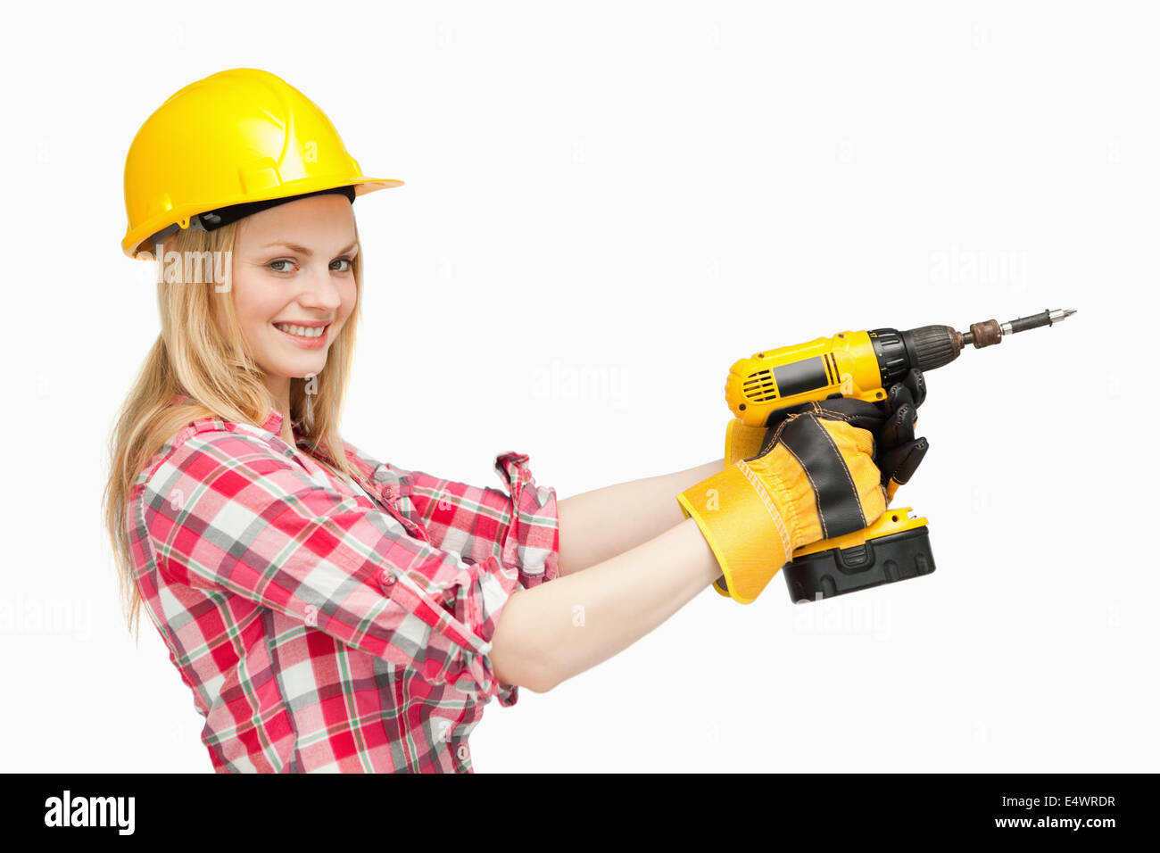 Smiling woman using an electric screwdriver Stock Photo - Alamy