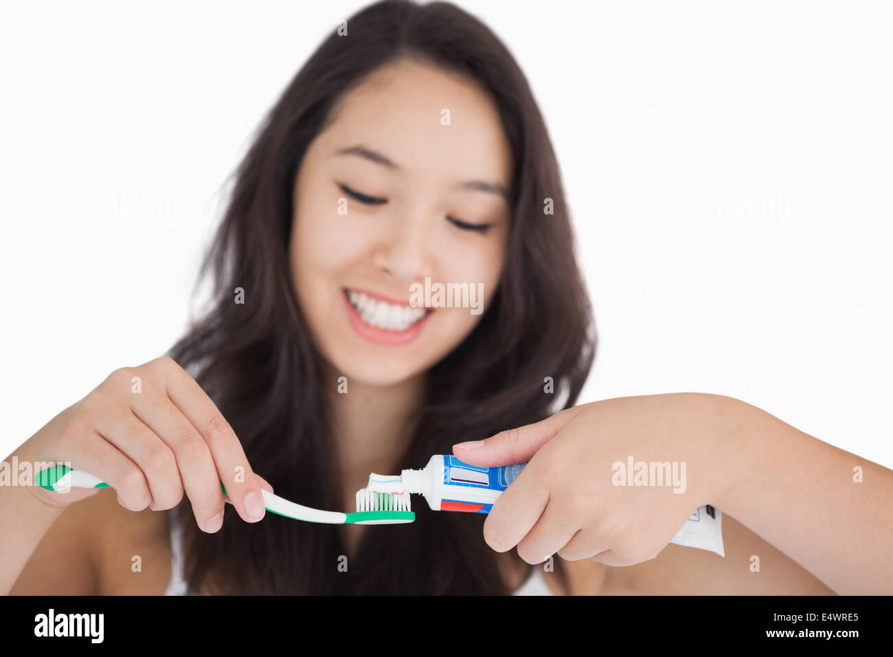 Woman putting toothpaste on toothbrush Stock Photo - Alamy