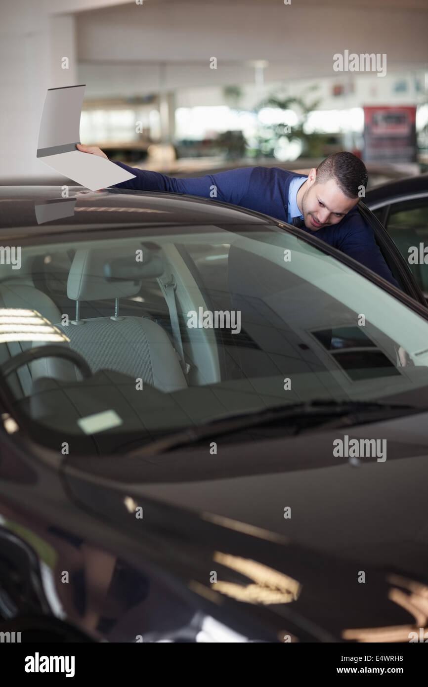 Dealer looking into a car Stock Photo - Alamy