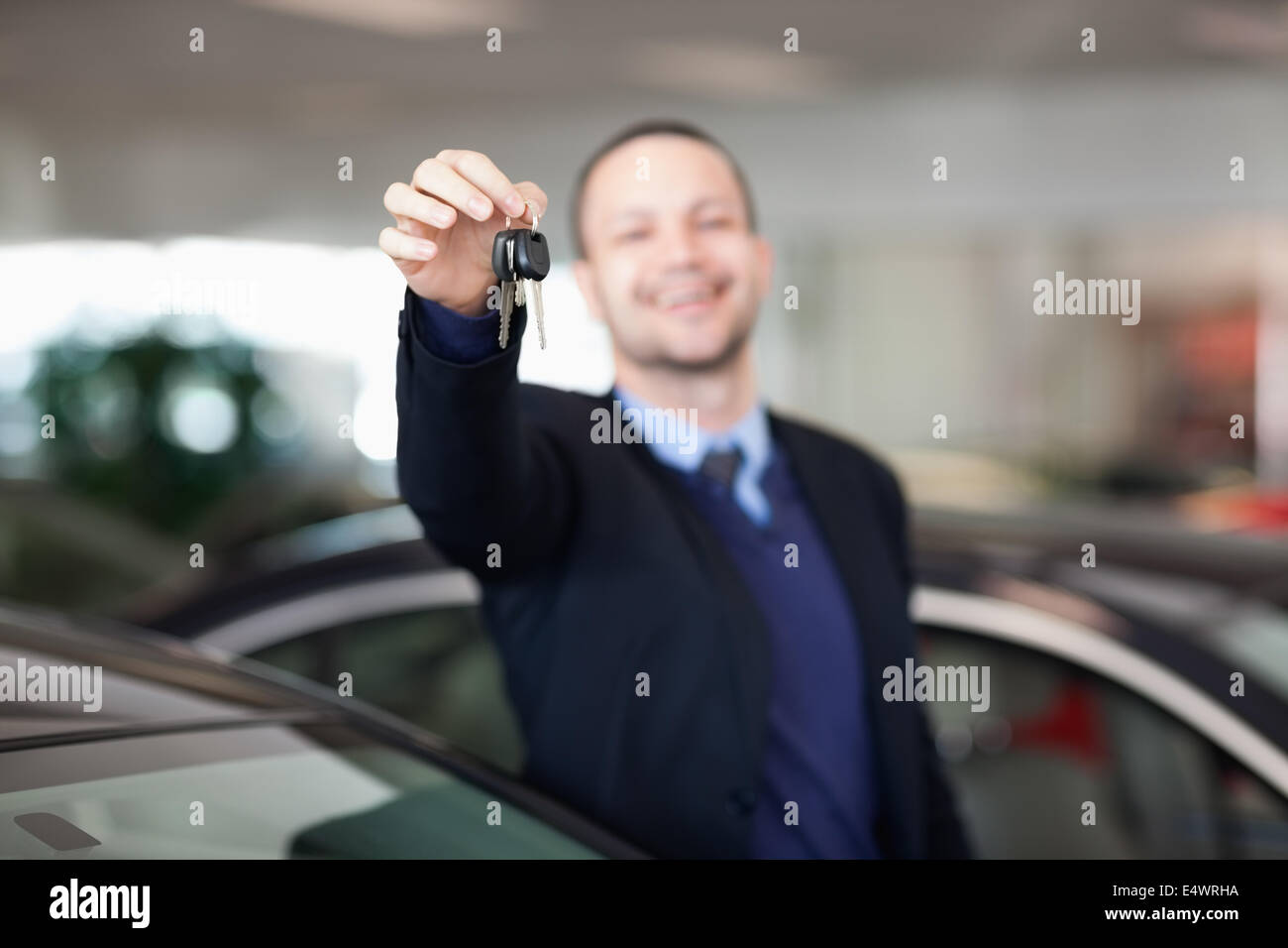 Man standing while holding car keys Stock Photo - Alamy